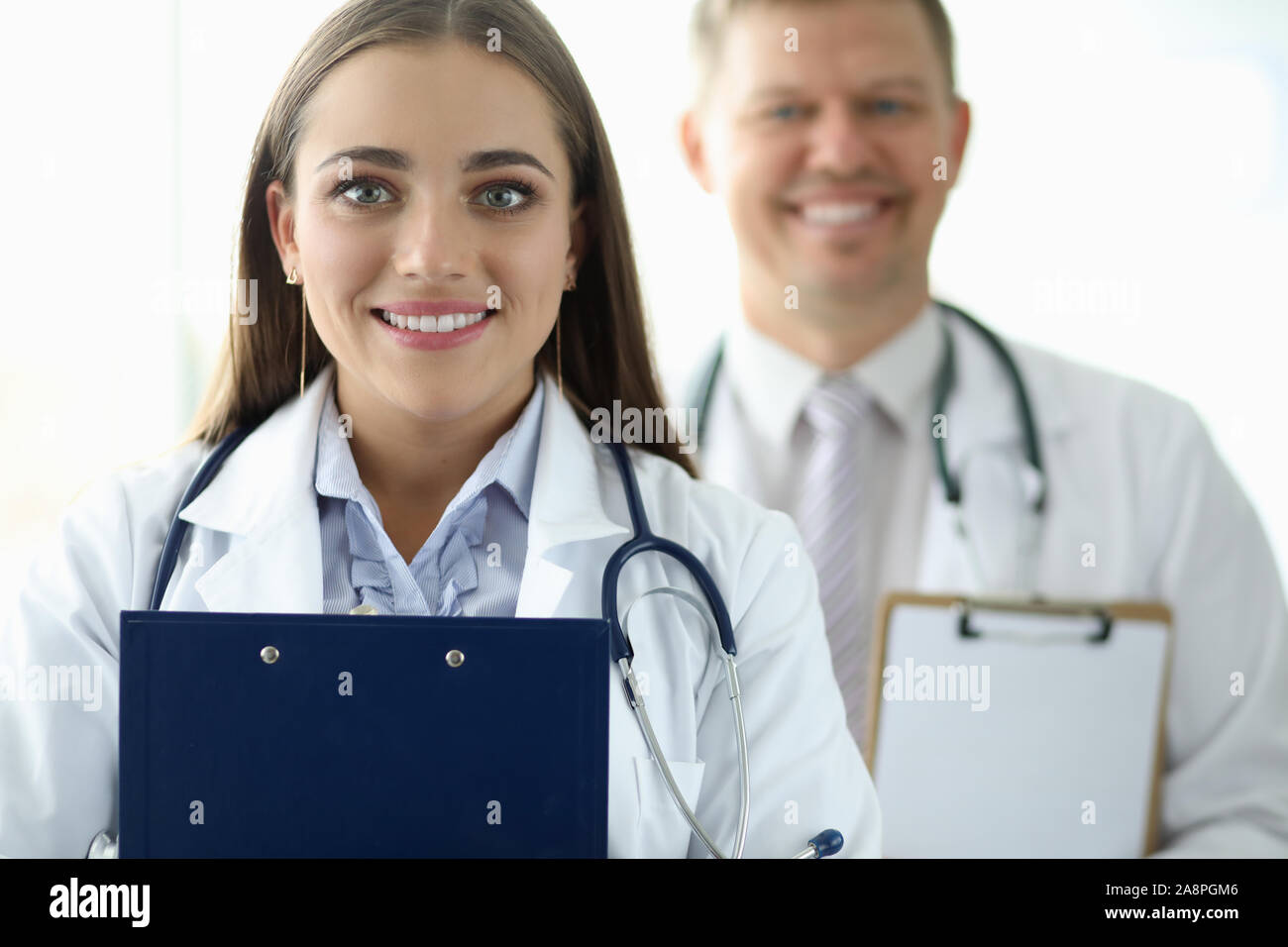 Doctor holding paper folder Stock Photo - Alamy