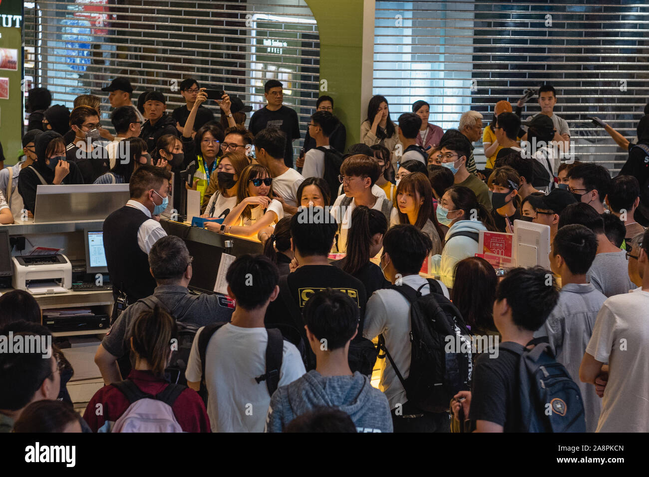 People surround a reception desk demanding to know where the mall ...