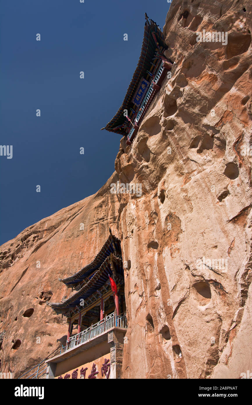 Caves carved into the cliff's face at the buddhist monastery of Mati Si ...