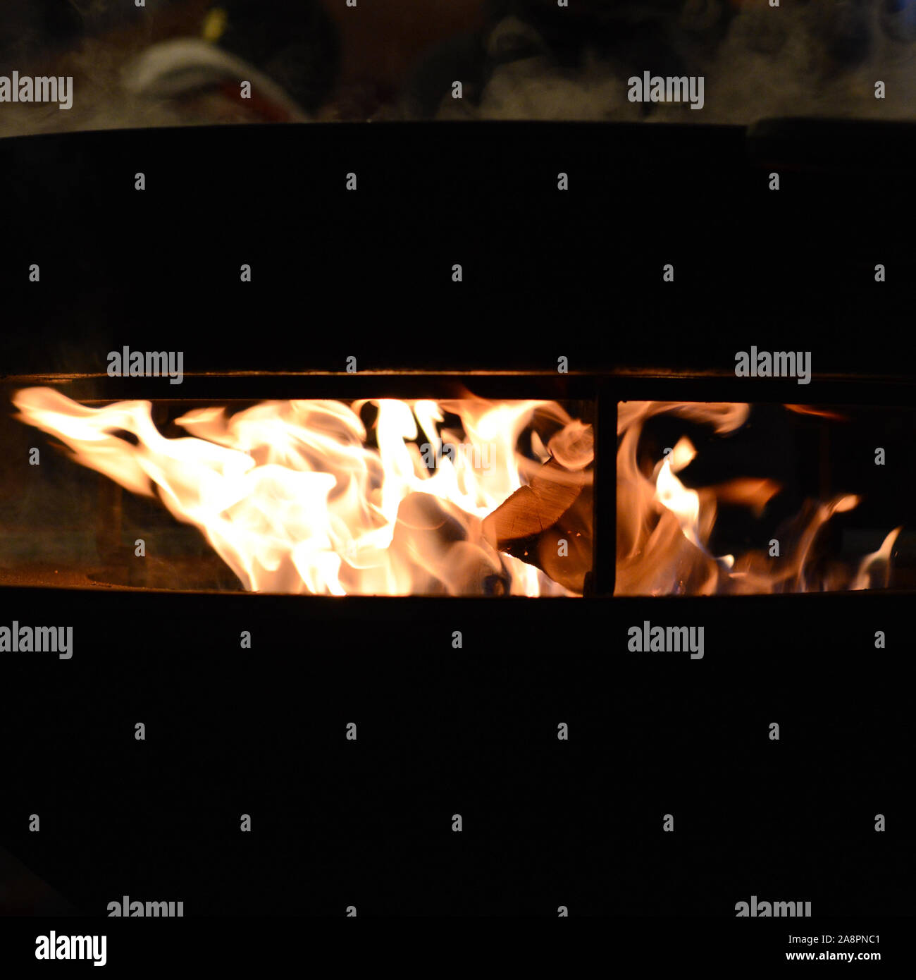 fire under a big black frying pan, burning wood, energy heat concept ...