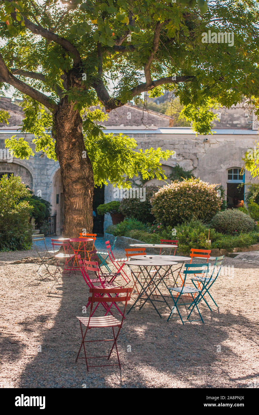 Outdoor cafe under a big tree in the evening outside in France Stock ...