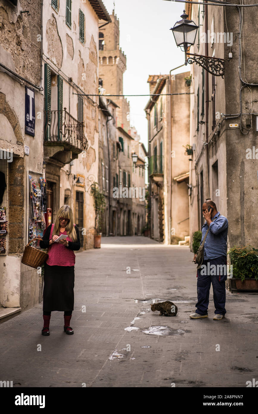 Local people in the street of the village Pitigliano, Tuscany, Italy ...