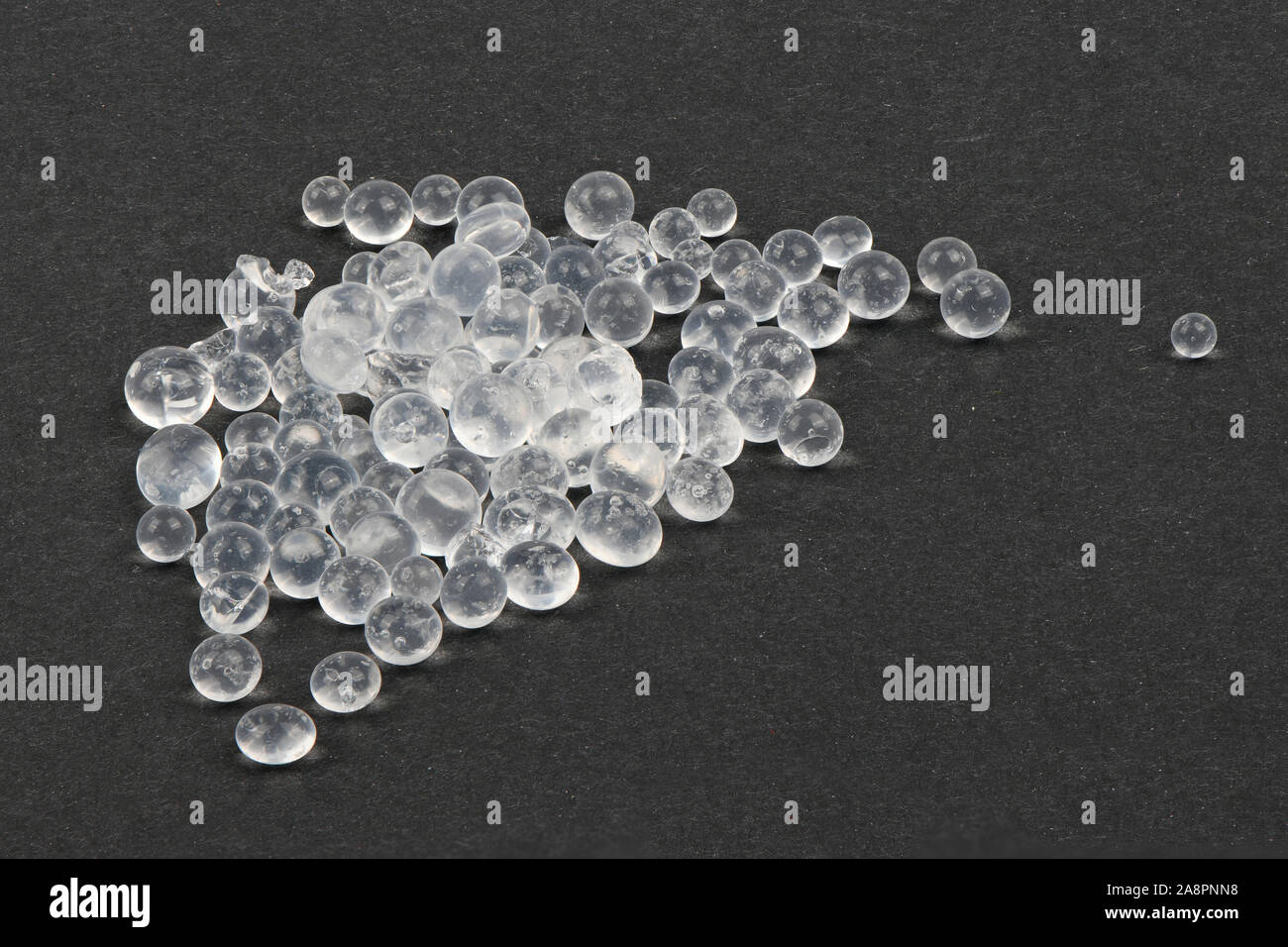 Polymer pellets. Pile of silica gel. Isolated on a black background ...