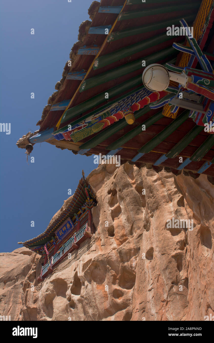 Caves carved into the cliff's face at the buddhist monastery of Mati Si ...