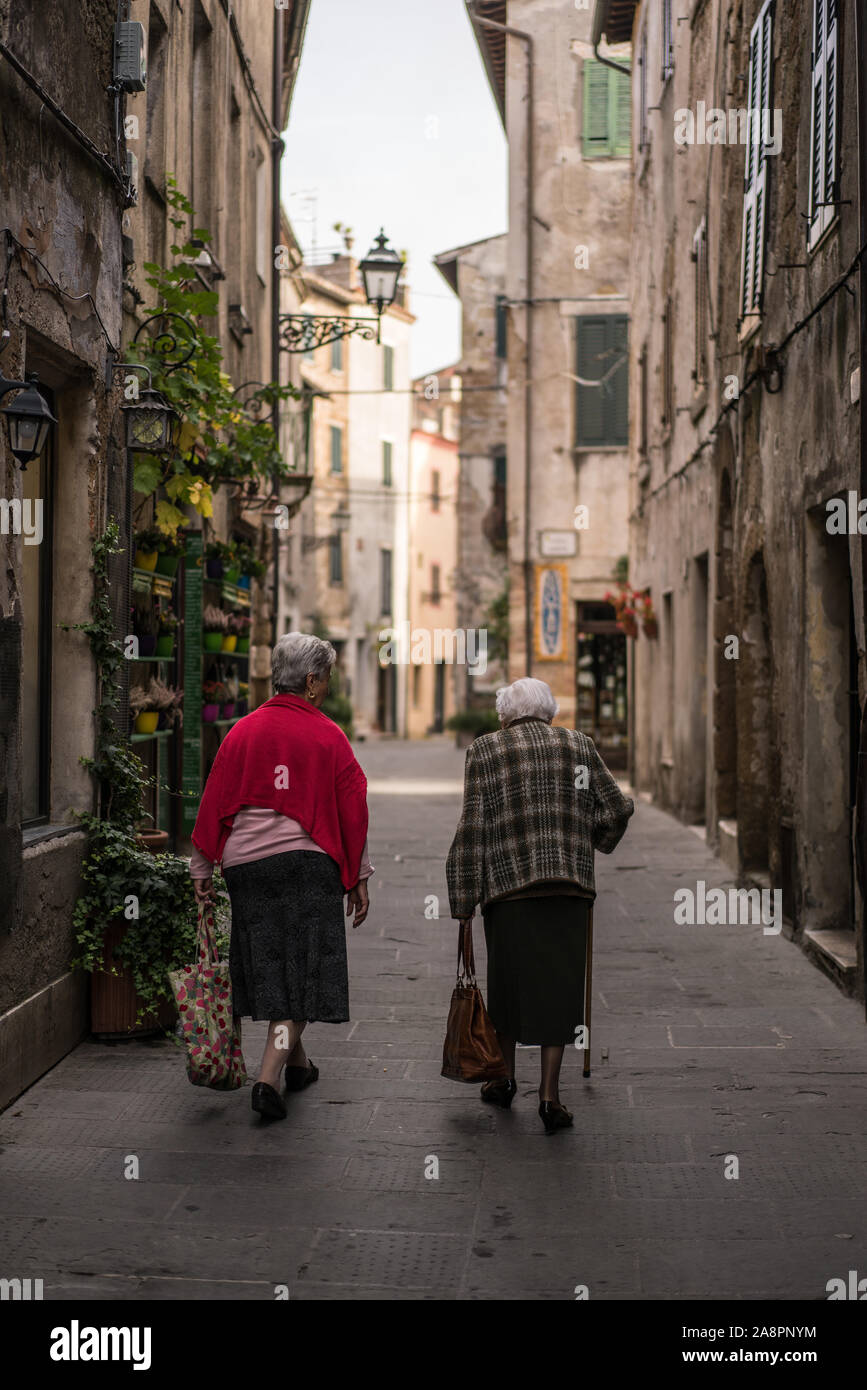 Local people in the street of the village Pitigliano, Tuscany, Italy ...