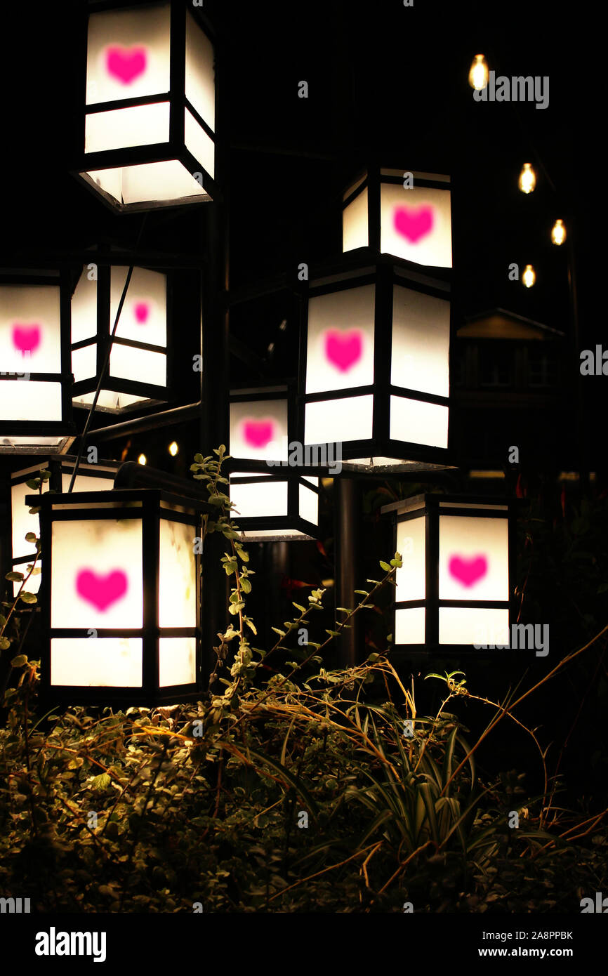 romantic lanterns light with red hearts in the night park for Valentine ...