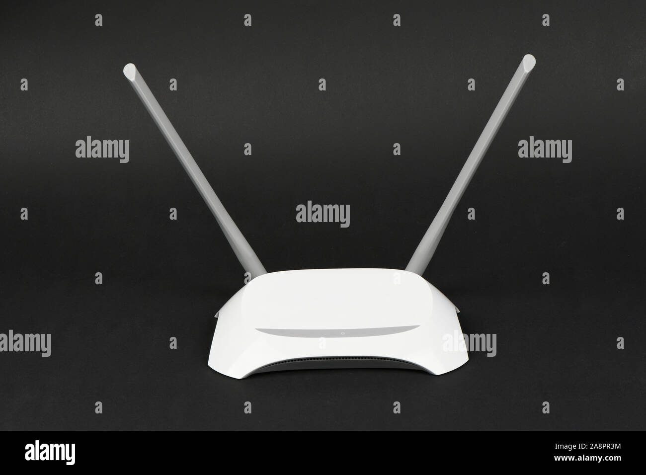 White WI-FI router with two antennas isolated on black background ...