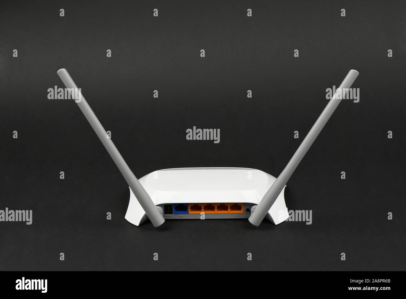 White WI-FI router with two antennas isolated on black background ...