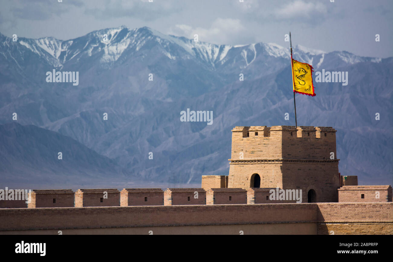 The snowcapped Qilian Mountains behind the ancient fort of Jiayuguan, a ...