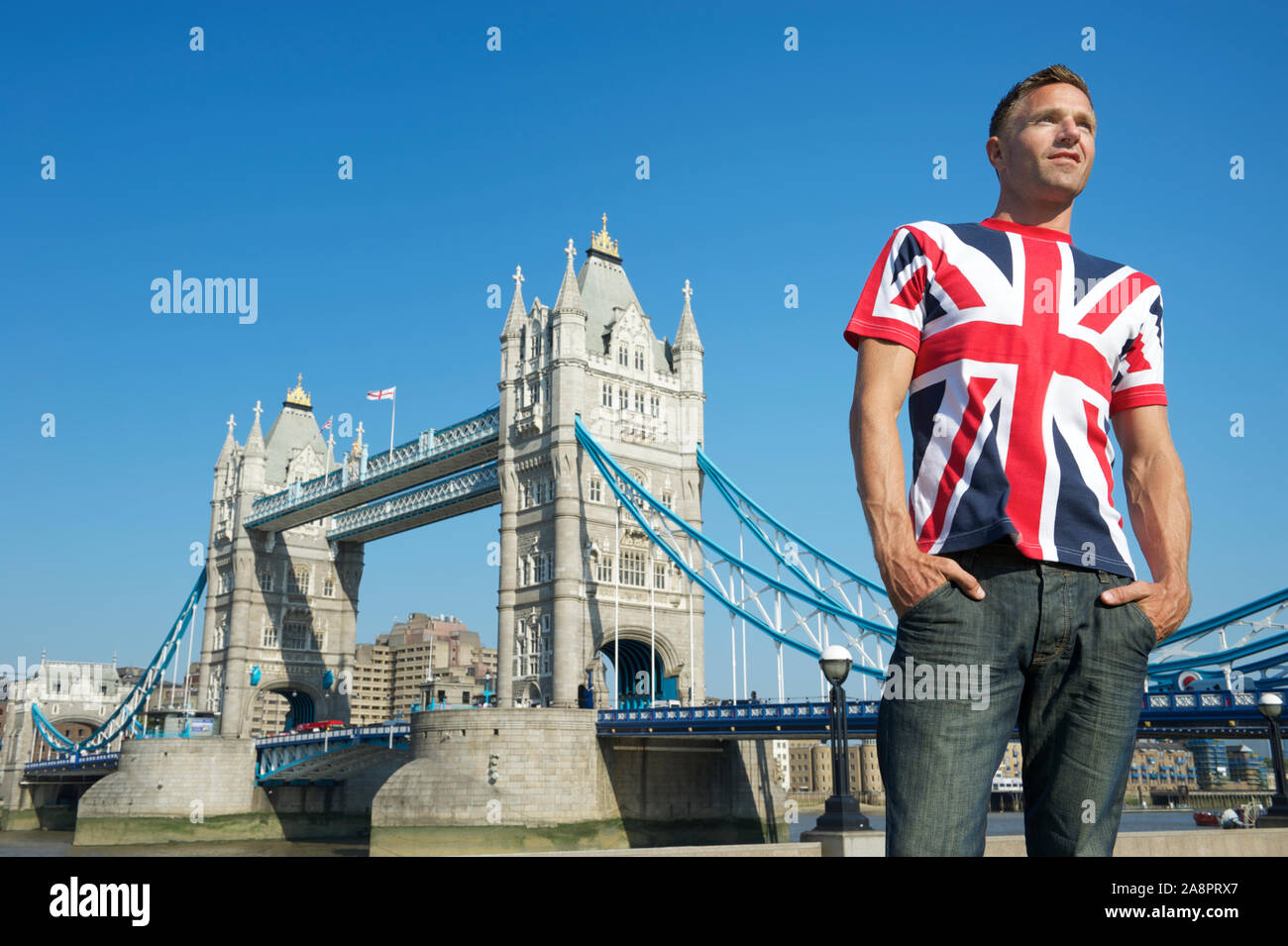 Patriotic young British man standing in a Union Jack T-shirt in front ...
