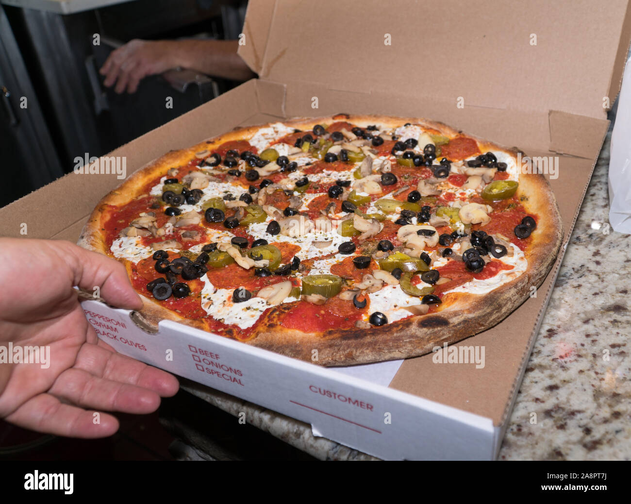 Delicious fresh pizza hot out of coal fire brick over in delivery box ...