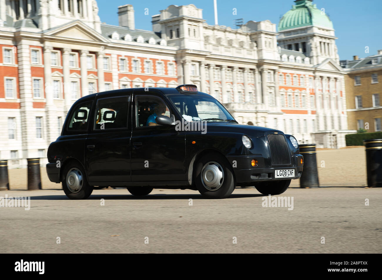 LONDON - OCTOBER 14, 2011: Traditional English black cab drives in ...