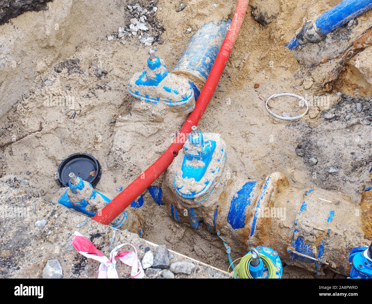 Blue water pipes and shut-off valve on 300mm pipe with plastic tube ...