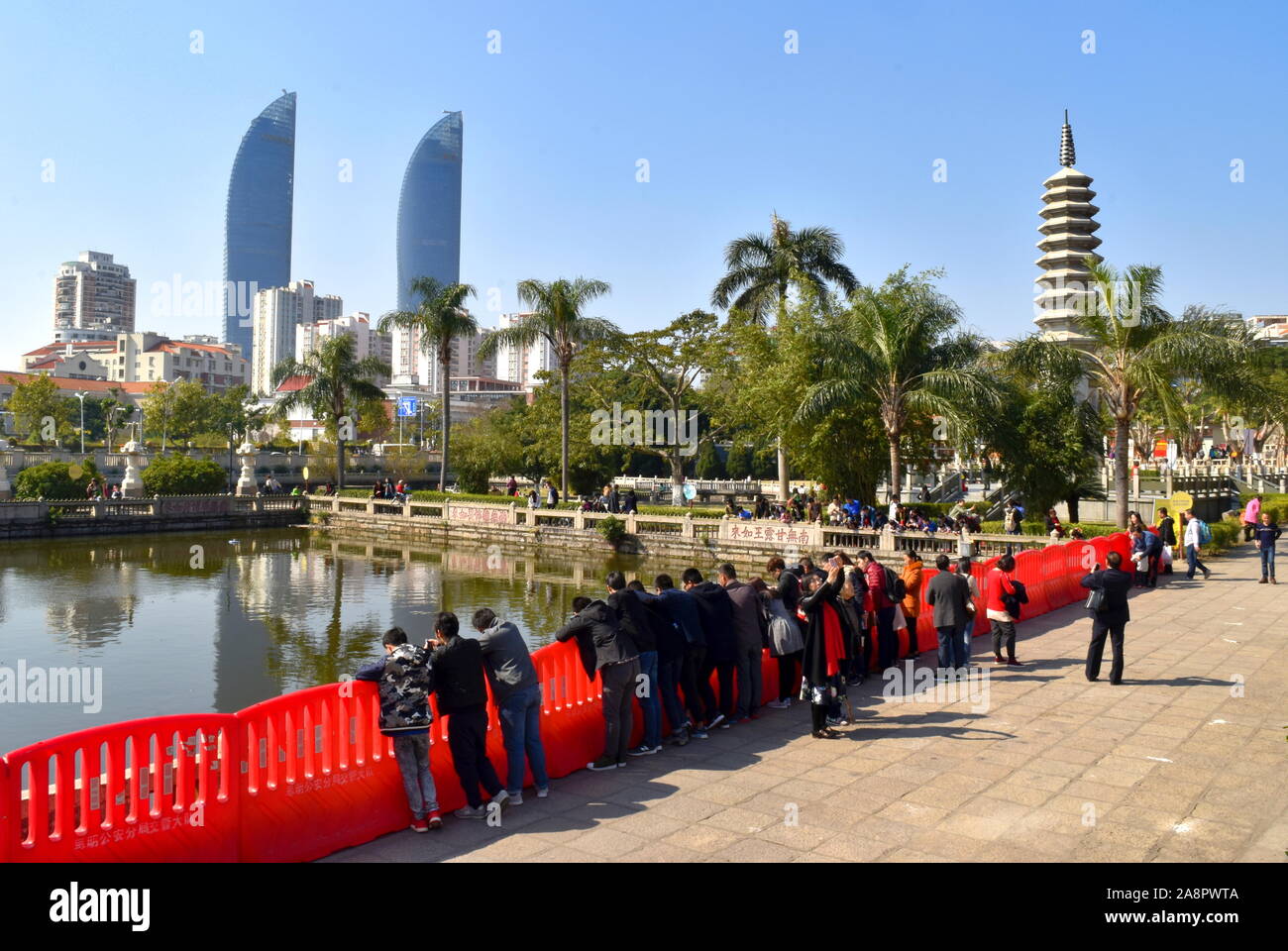 Xiamen city skyline by Nanputuo ancient Buddhist temple turtle pond ...