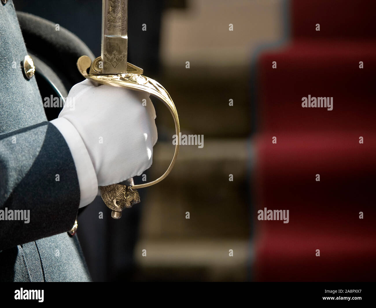 A soldier in military parade uniform holds a cavalry or naval sword ...