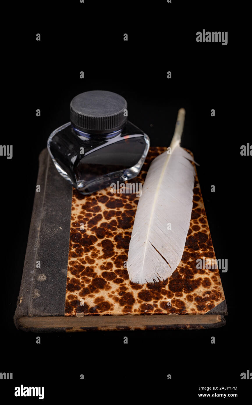 Blue ink, pen and old book. A place to write texts for the writer. Dark ...