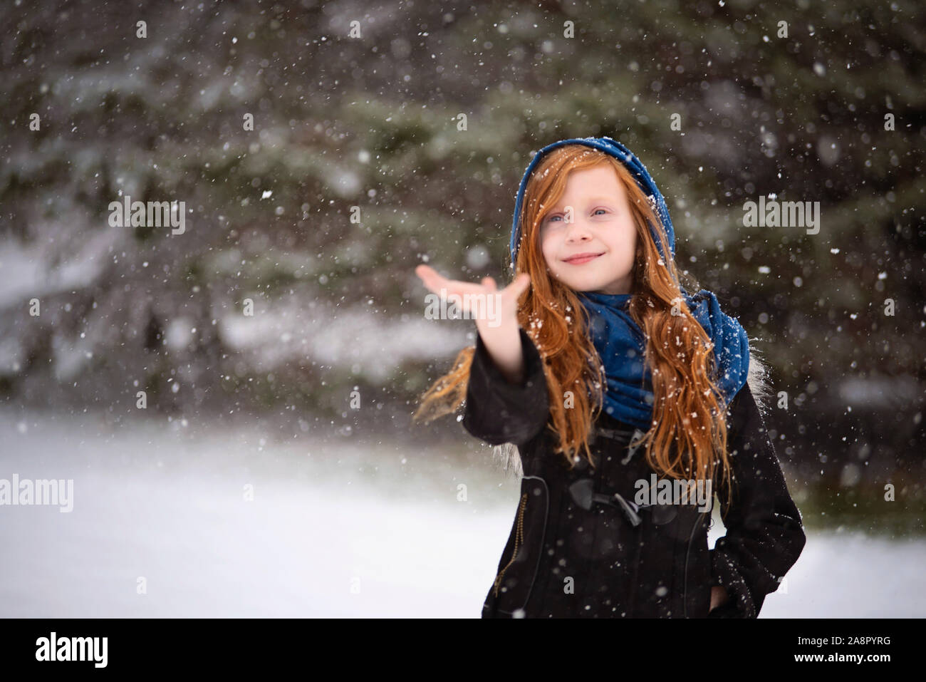 Young Red Haired Girl Playing outside in the Snow Stock Photo - Alamy