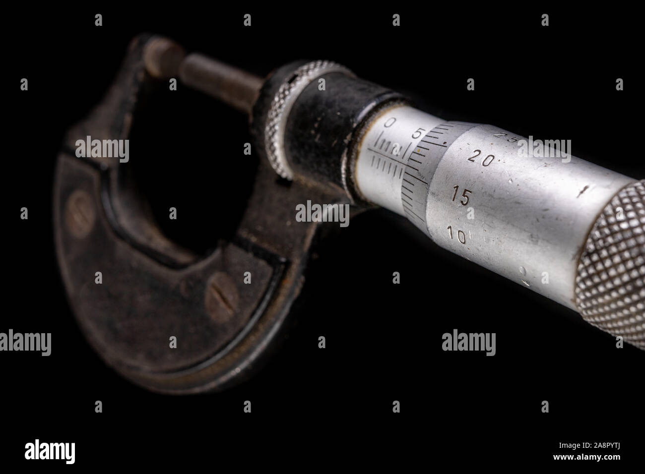 Micrometer on a dark workshop table. A tool for precise measurement in ...