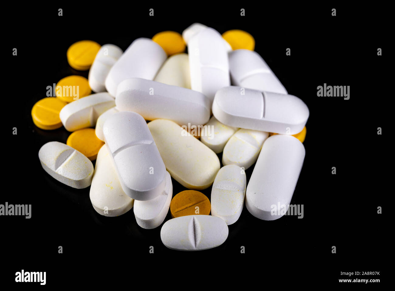 Medical tablets and tablet packaging. Medication on a dark table. Black ...