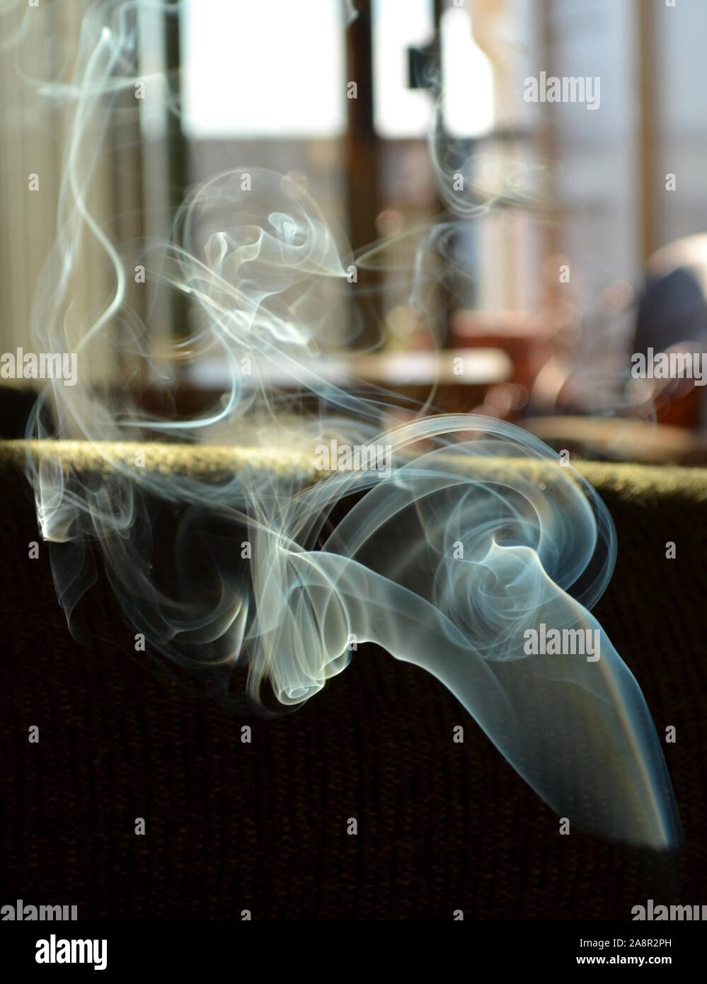 Incense smoke curls and ribbons in the air Stock Photo - Alamy