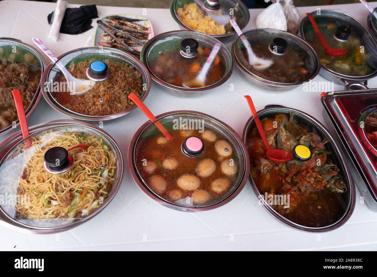 Typical Filipino food dishes ready for serving at a street food stall ...