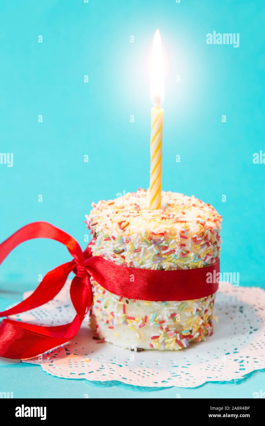 Birthday cake with a burning candle Stock Photo - Alamy