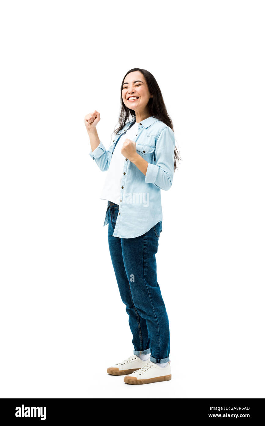 attractive and smiling asian woman in denim shirt showing yes gesture ...