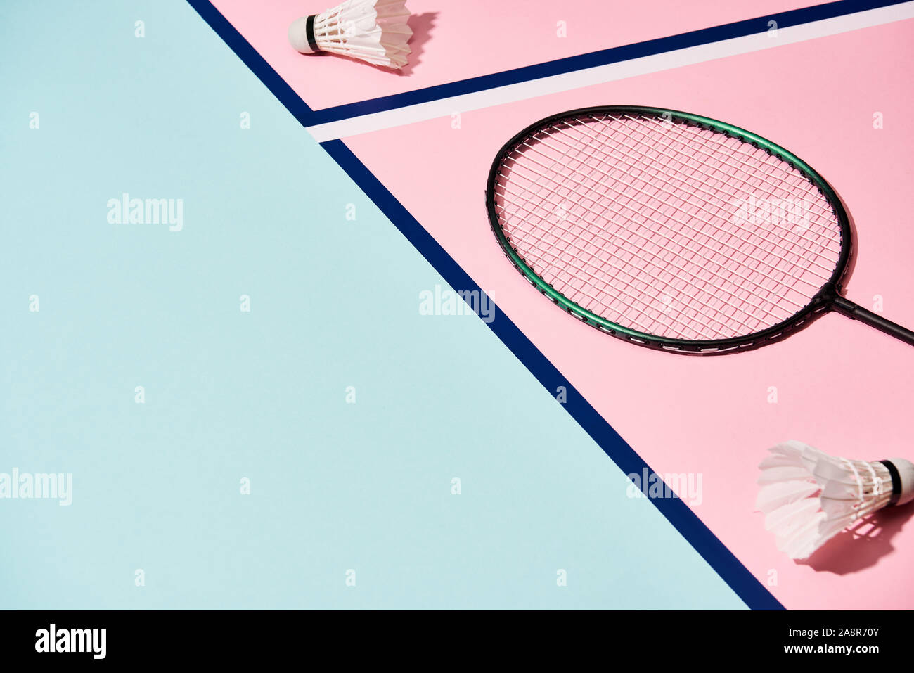 Badminton racket and shuttlecocks on colorful surface with blue lines ...