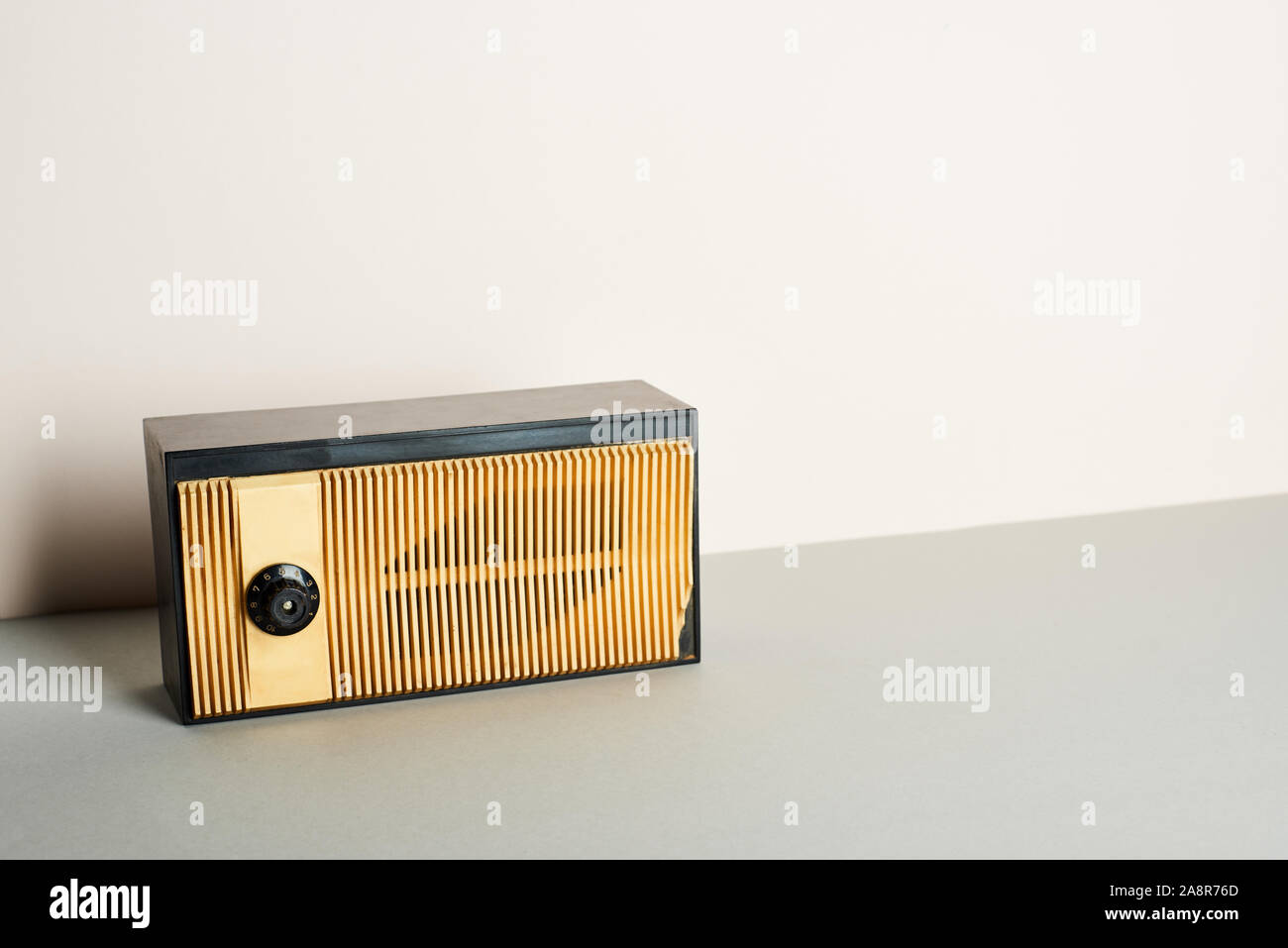 Retro radio on grey surface and white background Stock Photo - Alamy