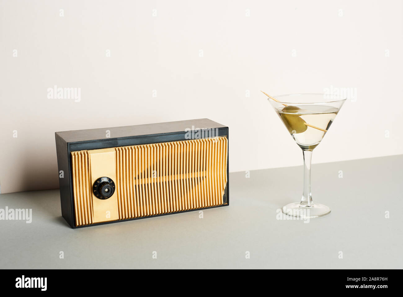 Vintage radio with glass of martini cocktail on grey surface Stock ...