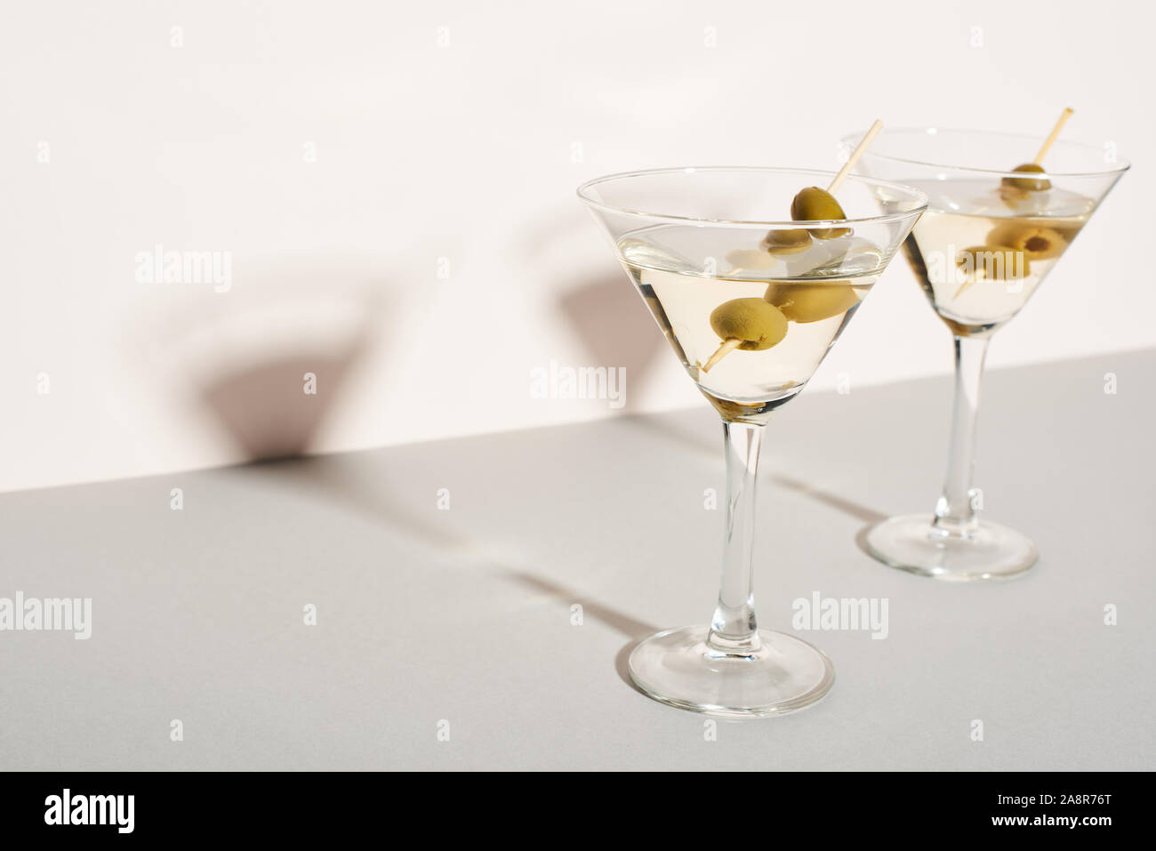 Martini cocktails with olives on white background Stock Photo - Alamy