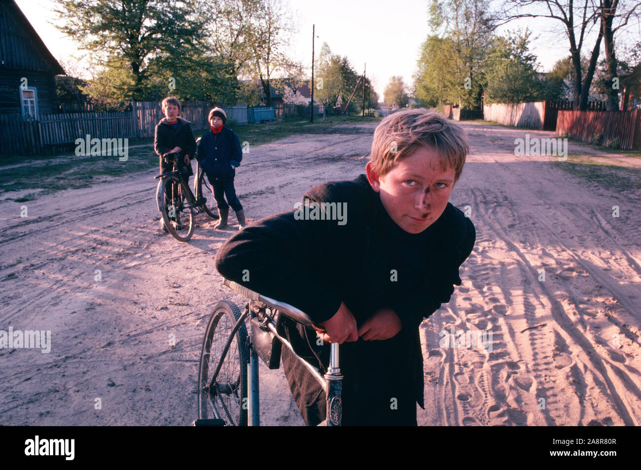 School boys on a dirt street in Narodychi in the Polesia region of the ...