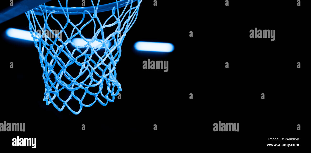 Basketball hoop isolated on black background. Blue filter Stock Photo ...