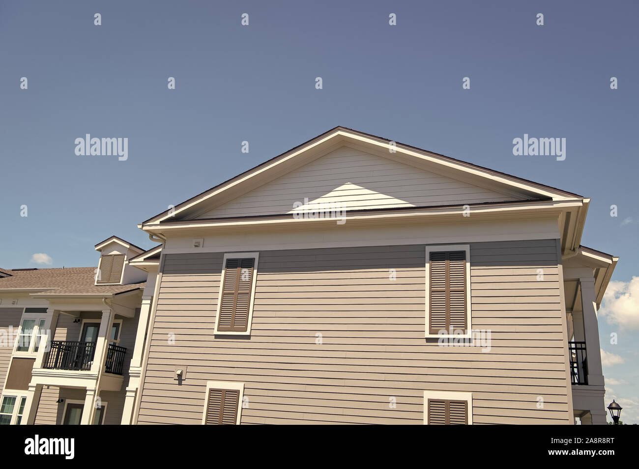 side view of house building. house roof on blue sunny sky background ...