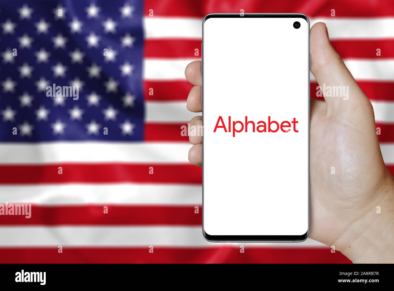 Logo of public company Alphabet Inc displayed on a smartphone. Flag of ...