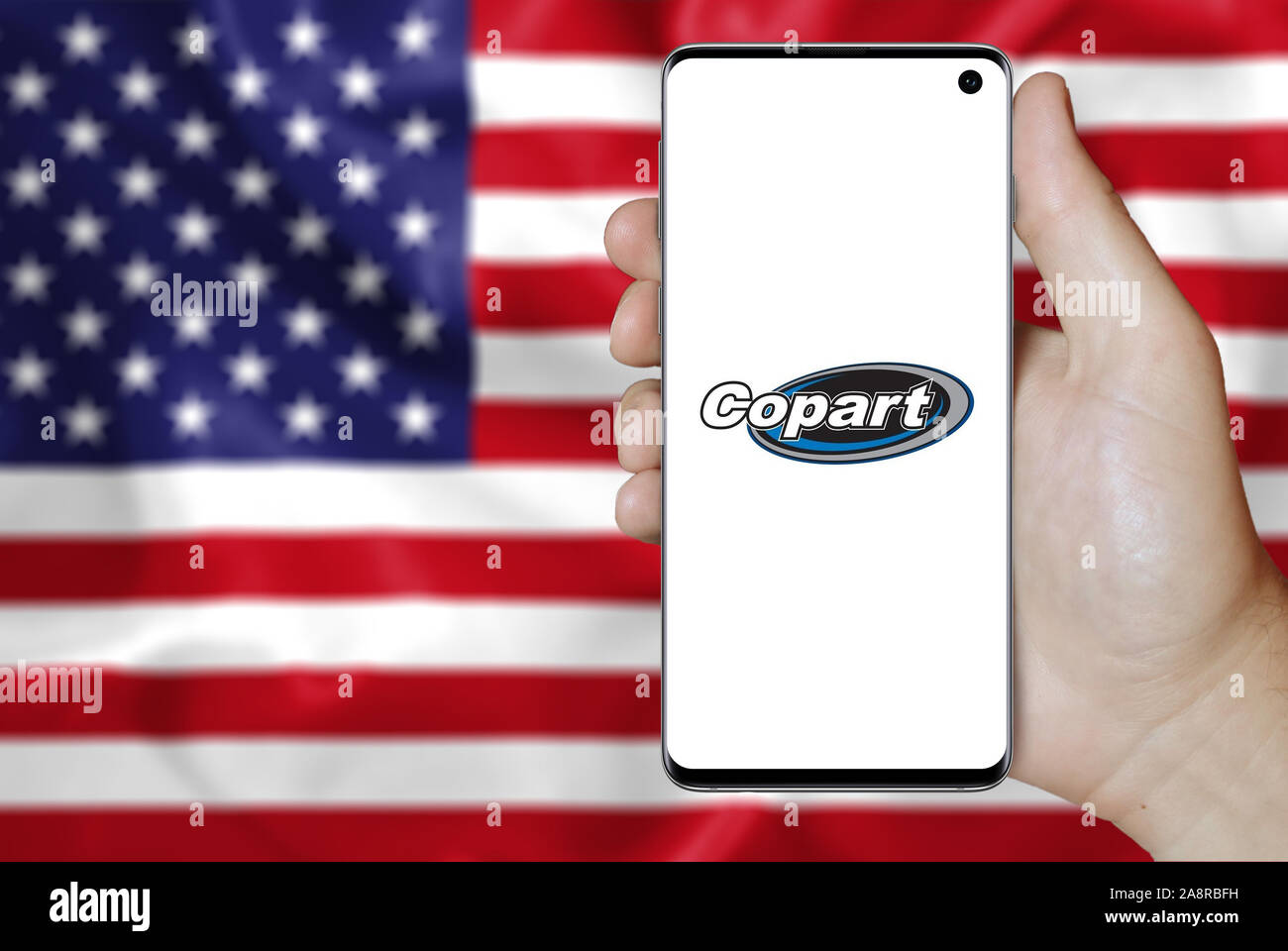 Logo of public company Copart Inc displayed on a smartphone. Flag of ...