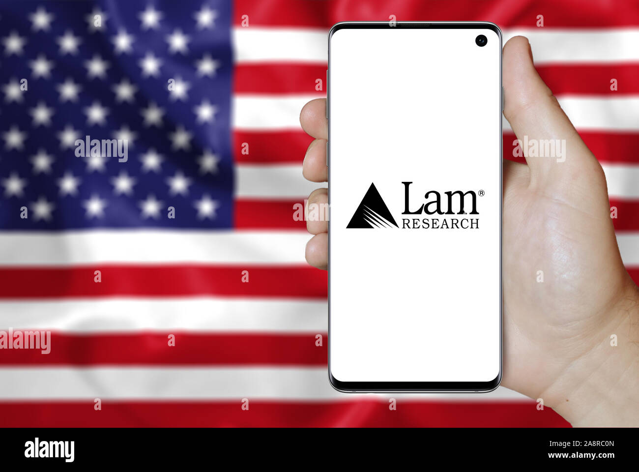 Logo of public company Lam Research displayed on a smartphone. Flag of ...