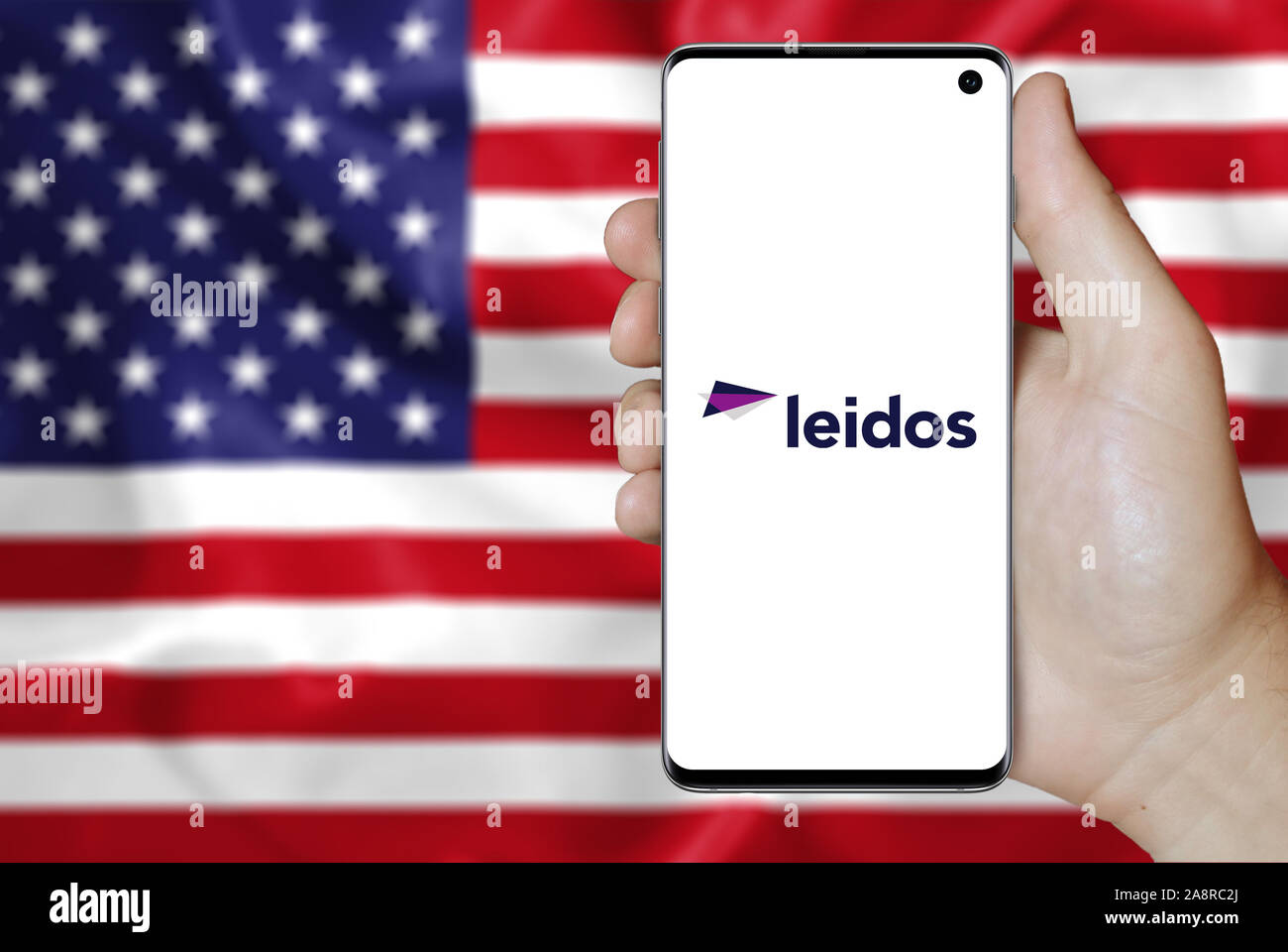 Logo of public company Leidos Holdings displayed on a smartphone. Flag ...