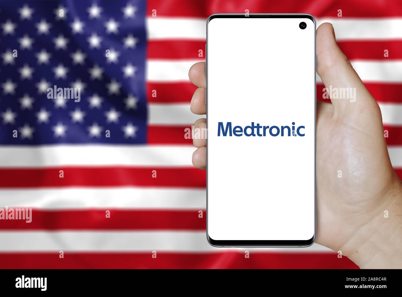 Logo of public company Medtronic plc displayed on a smartphone. Flag of ...