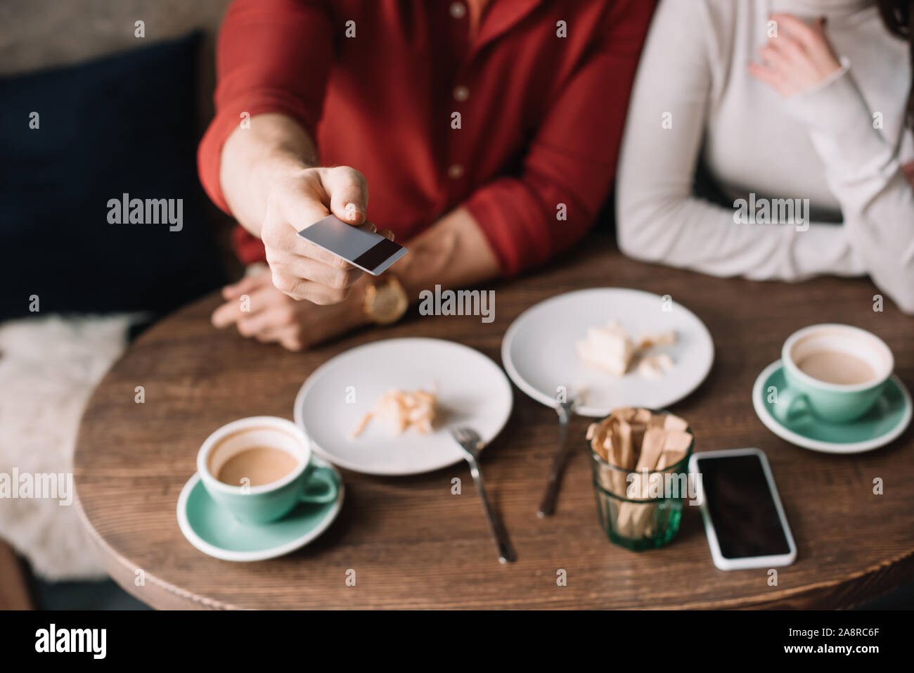 Young man woman eating cake restaurant hi-res stock photography and ...