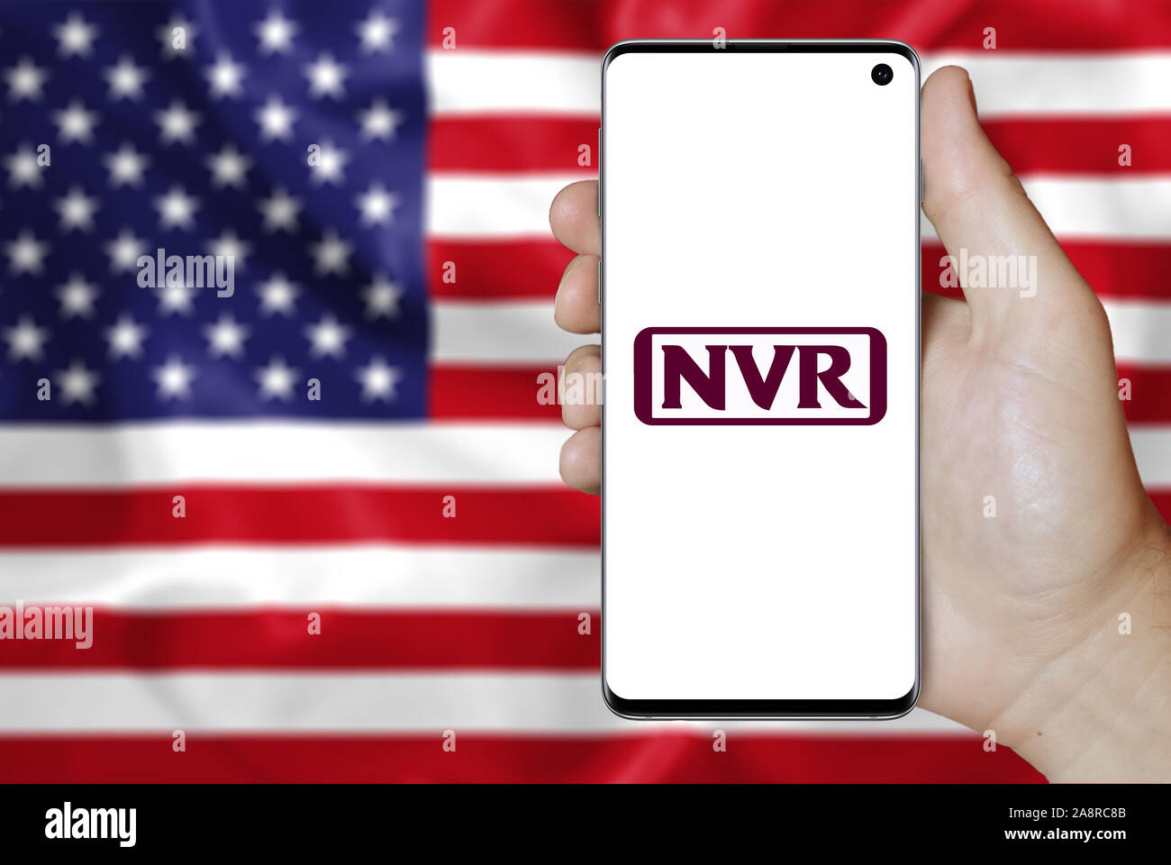 Logo of public company NVR Inc displayed on a smartphone. Flag of USA background. Credit ...