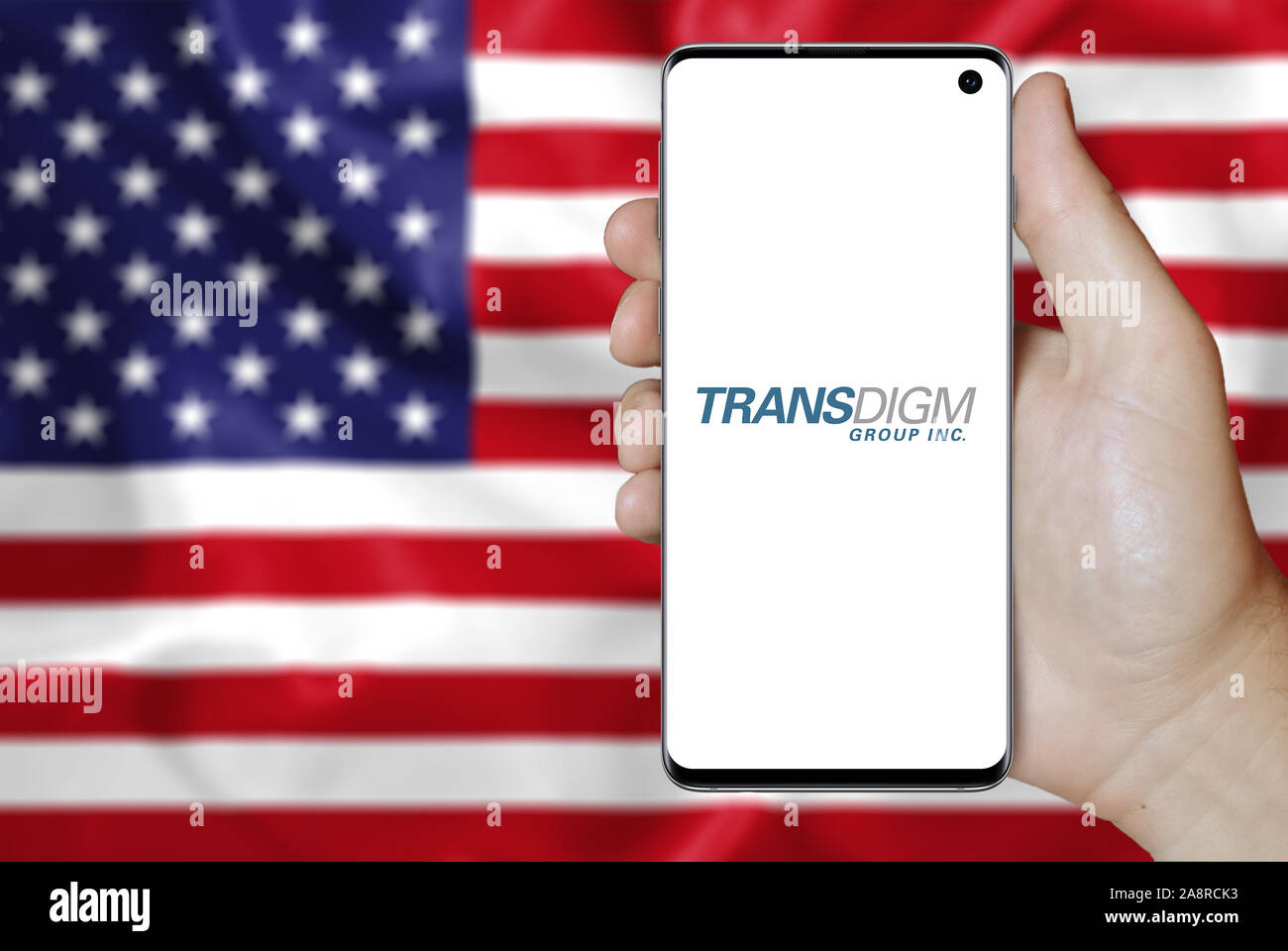Logo of public company TransDigm Group displayed on a smartphone. Flag ...