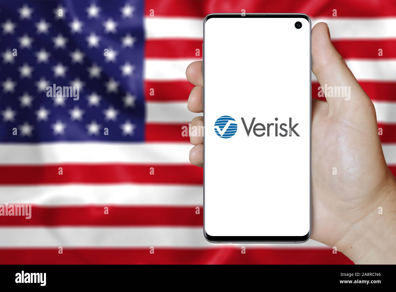 Logo of public company Verisk Analytics displayed on a smartphone. Flag ...