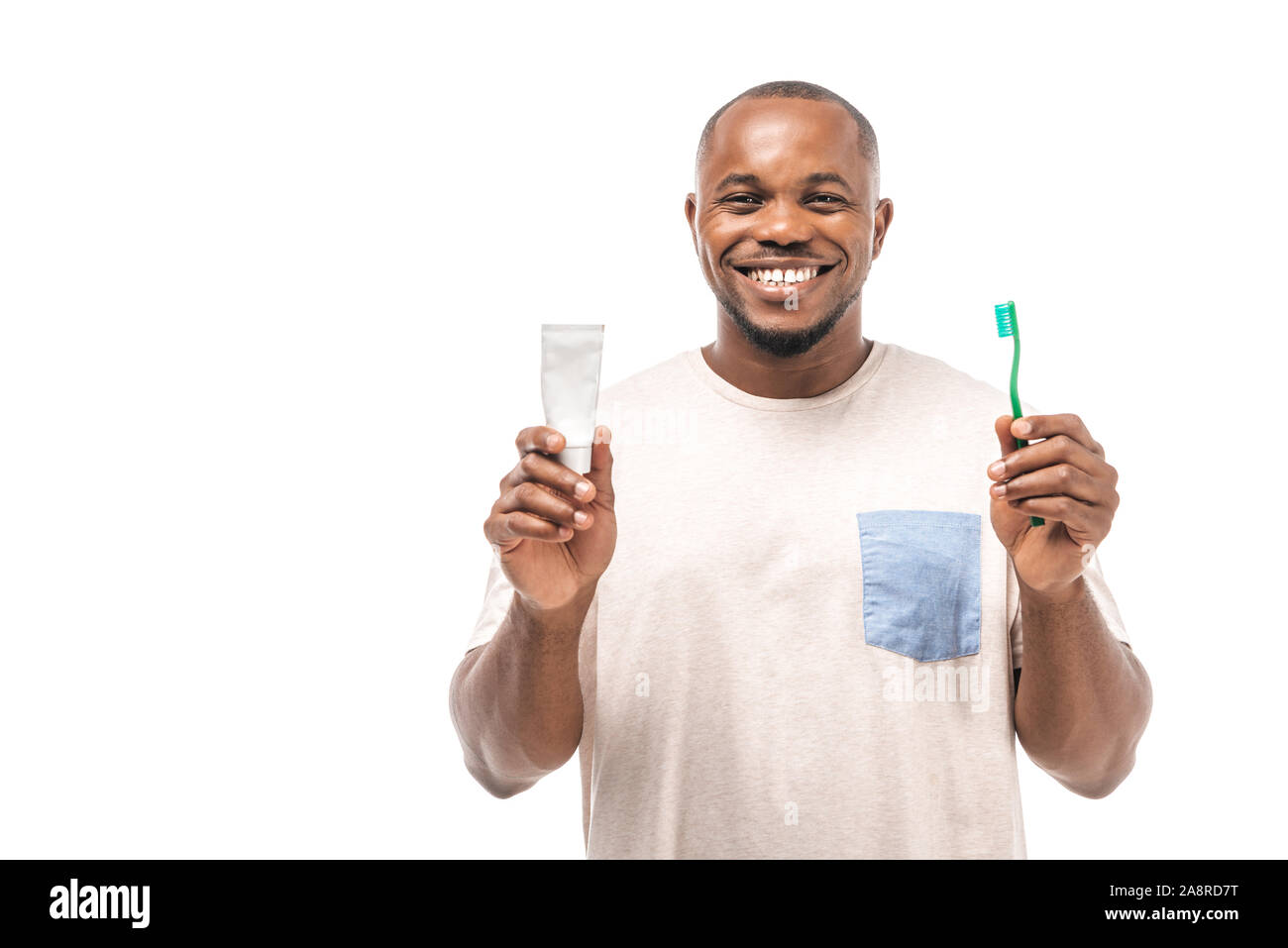 cheerful african american man holding toothbrush and toothpaste and ...