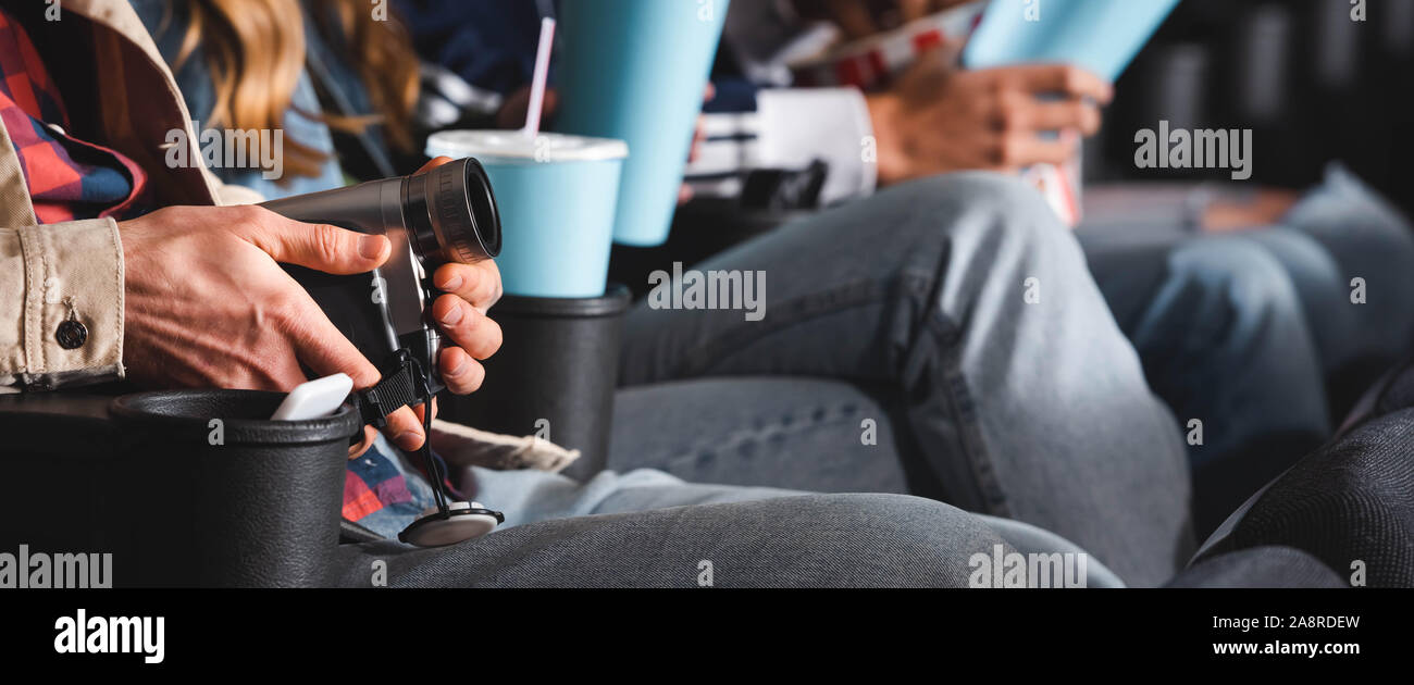 panoramic shot of man shooting with digital camera in cinema Stock ...
