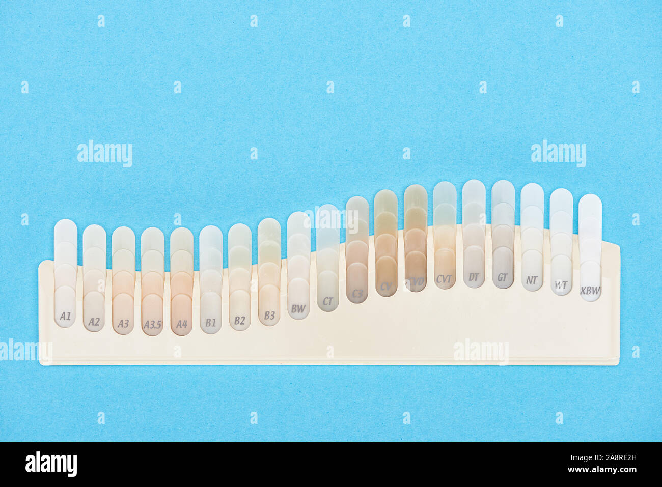 top view of teeth samples with different shades isolated on blue Stock ...