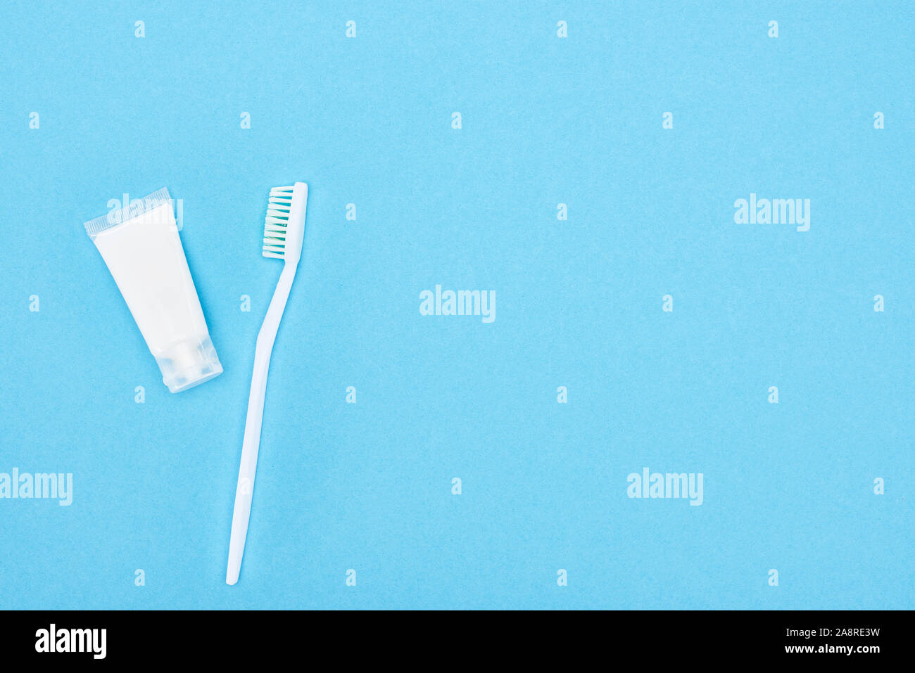 top view of white toothbrush and toothpaste isolated on blue Stock ...