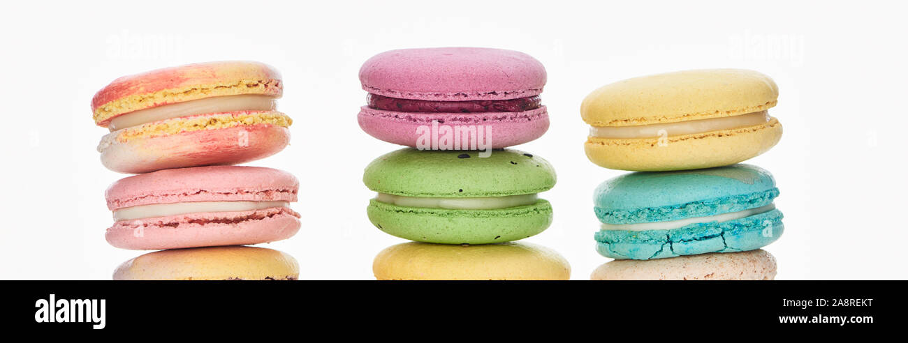 rows of sweet colorful French macaroons of different flavors isolated ...