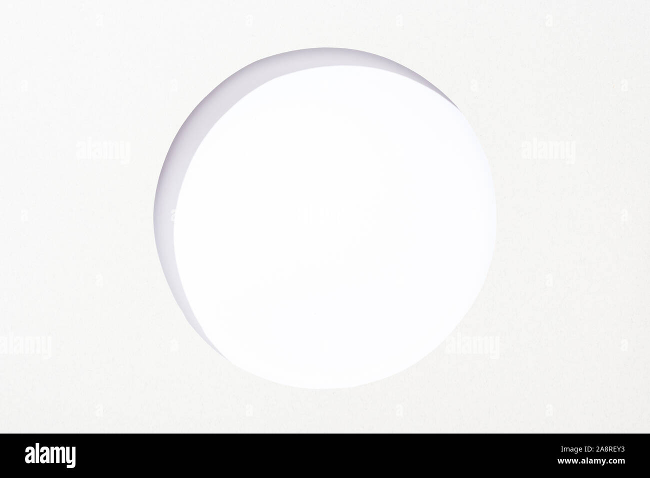 cut out round hole in white paper on white background Stock Photo - Alamy