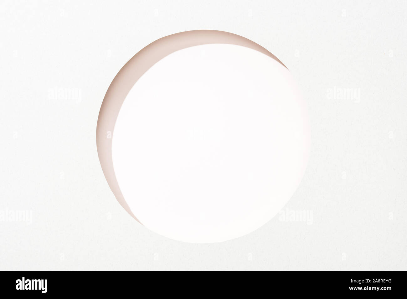 cut out round hole in white paper on white background Stock Photo - Alamy